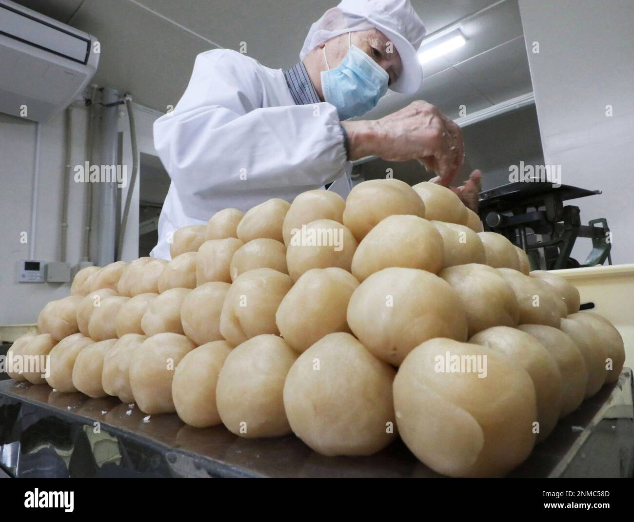 Japanese pastry chef is making Yahata manjyu, bun containing a white ...