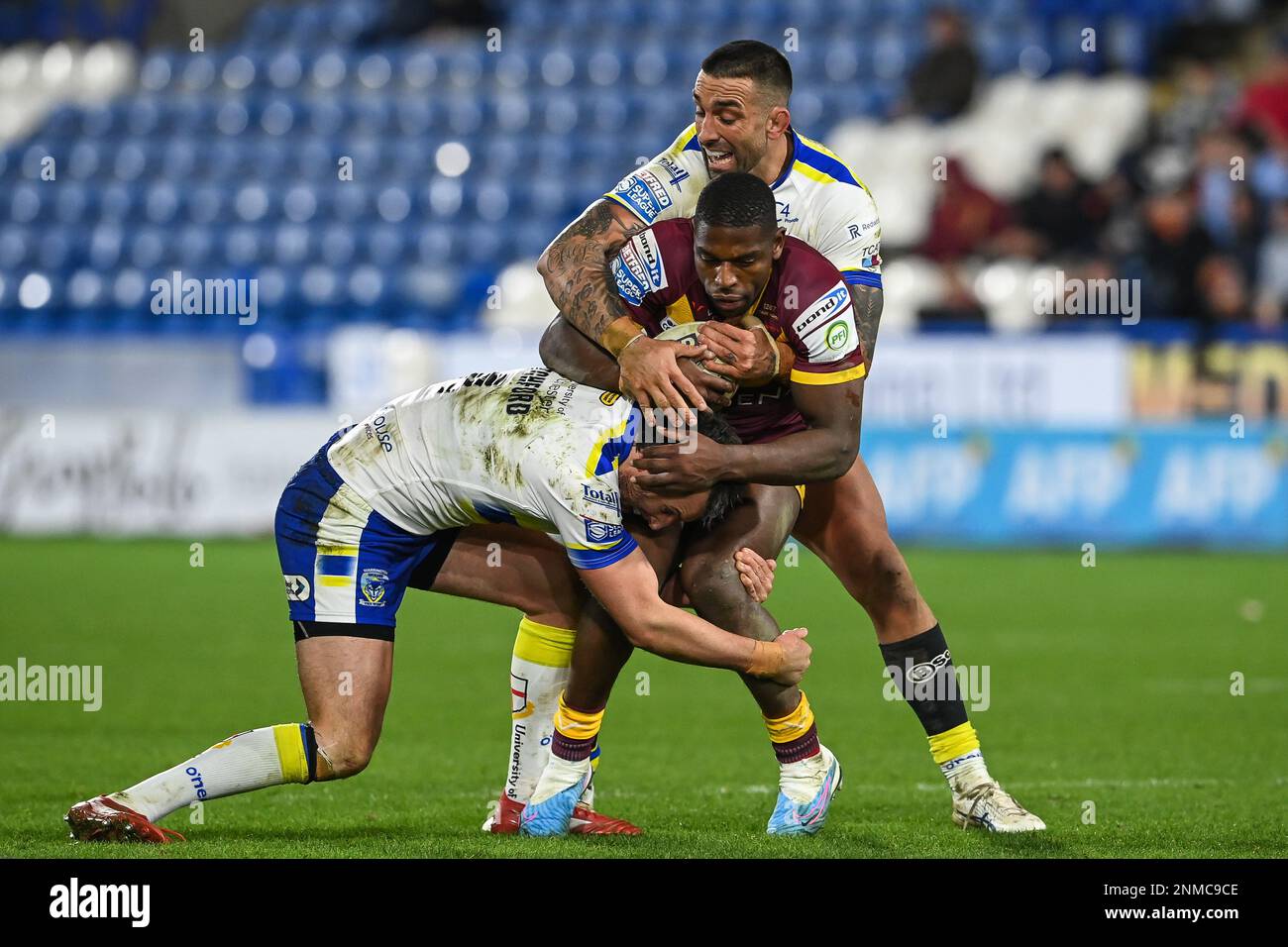 Jermaine McGillvary #2 of Huddersfield Giants is tackled by Paul ...