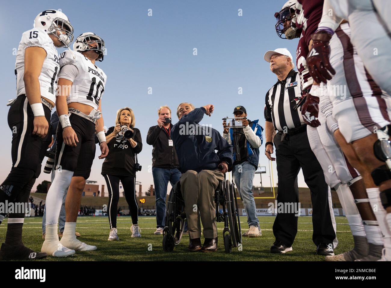 Texas Gov. Greg Abbott tosses the coin at the start of the high school ...