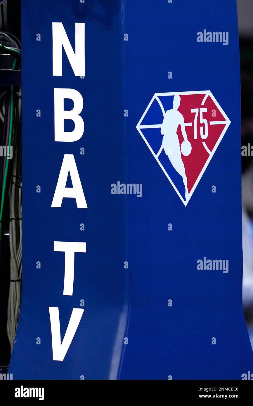 The NBA's 75th anniversary logo is seen along with NBA TV on a basket ...