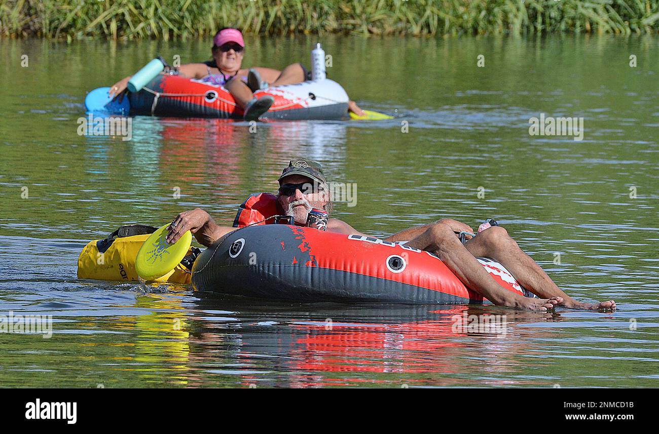 A man and woman use plastic discs to help navigate the Colorado River ...