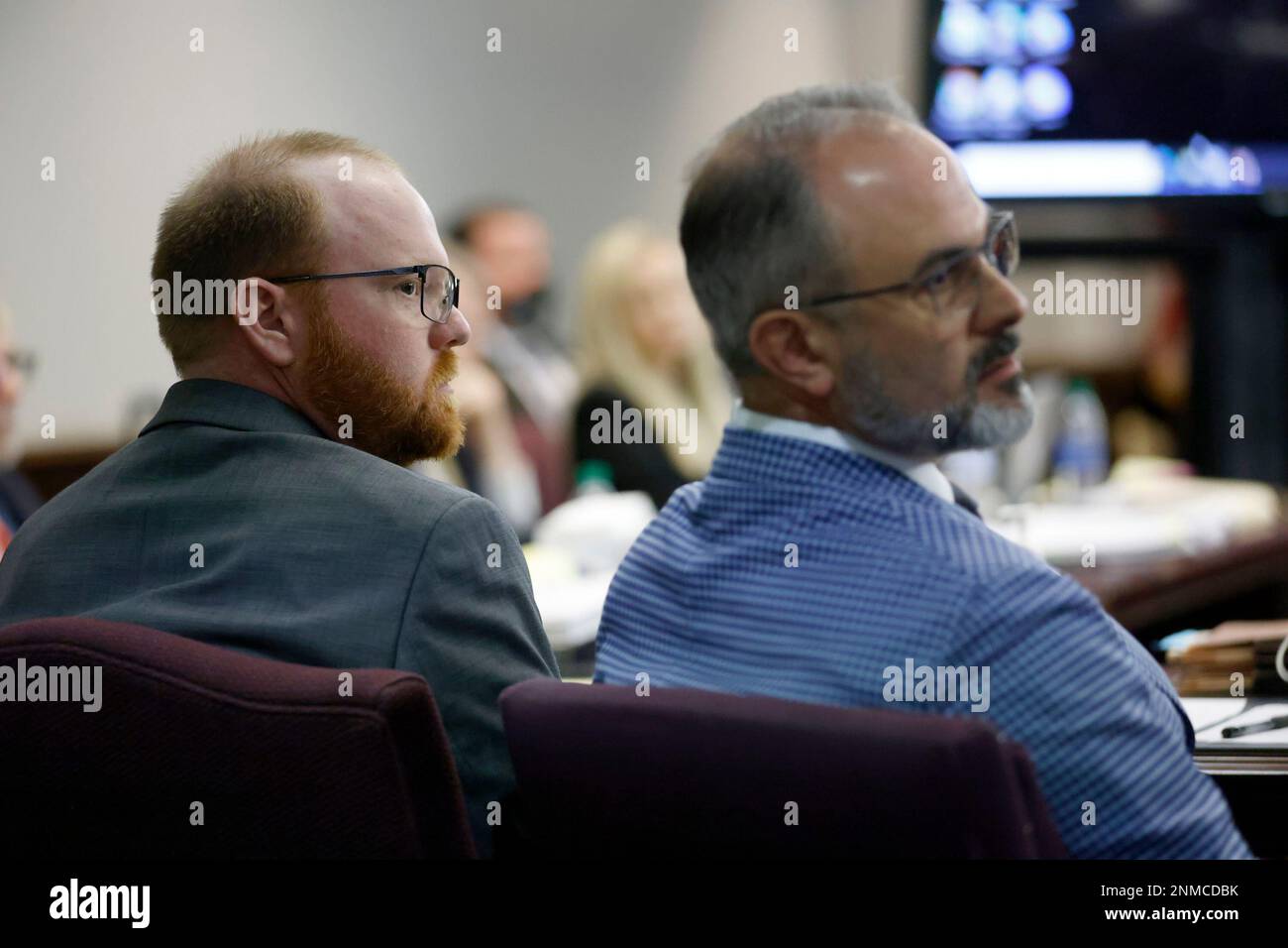 Travis McMichael, left, listens to opening statements in the trial of ...