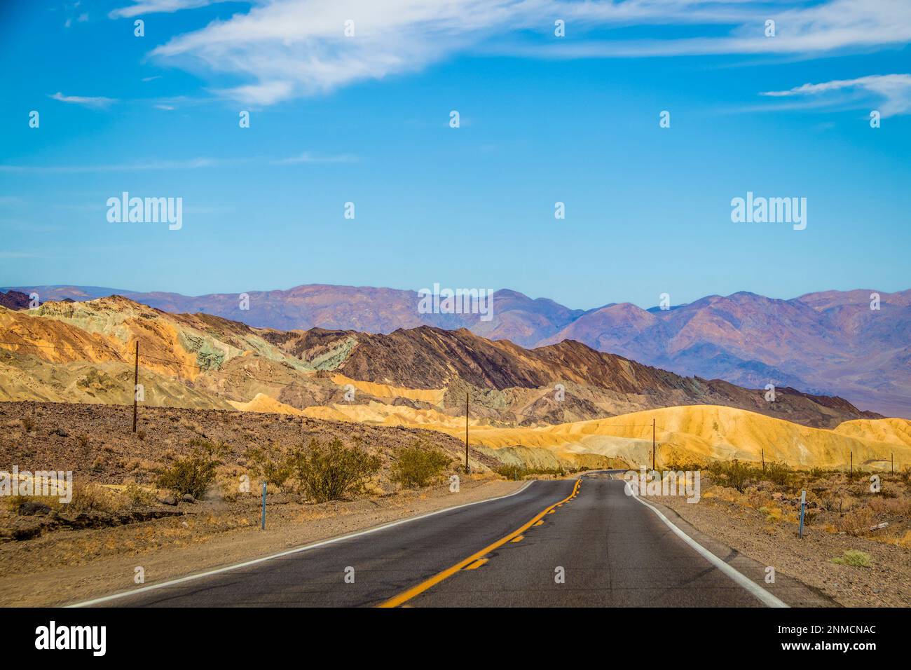 Two lane black topped road through Death Valley California USA with ...