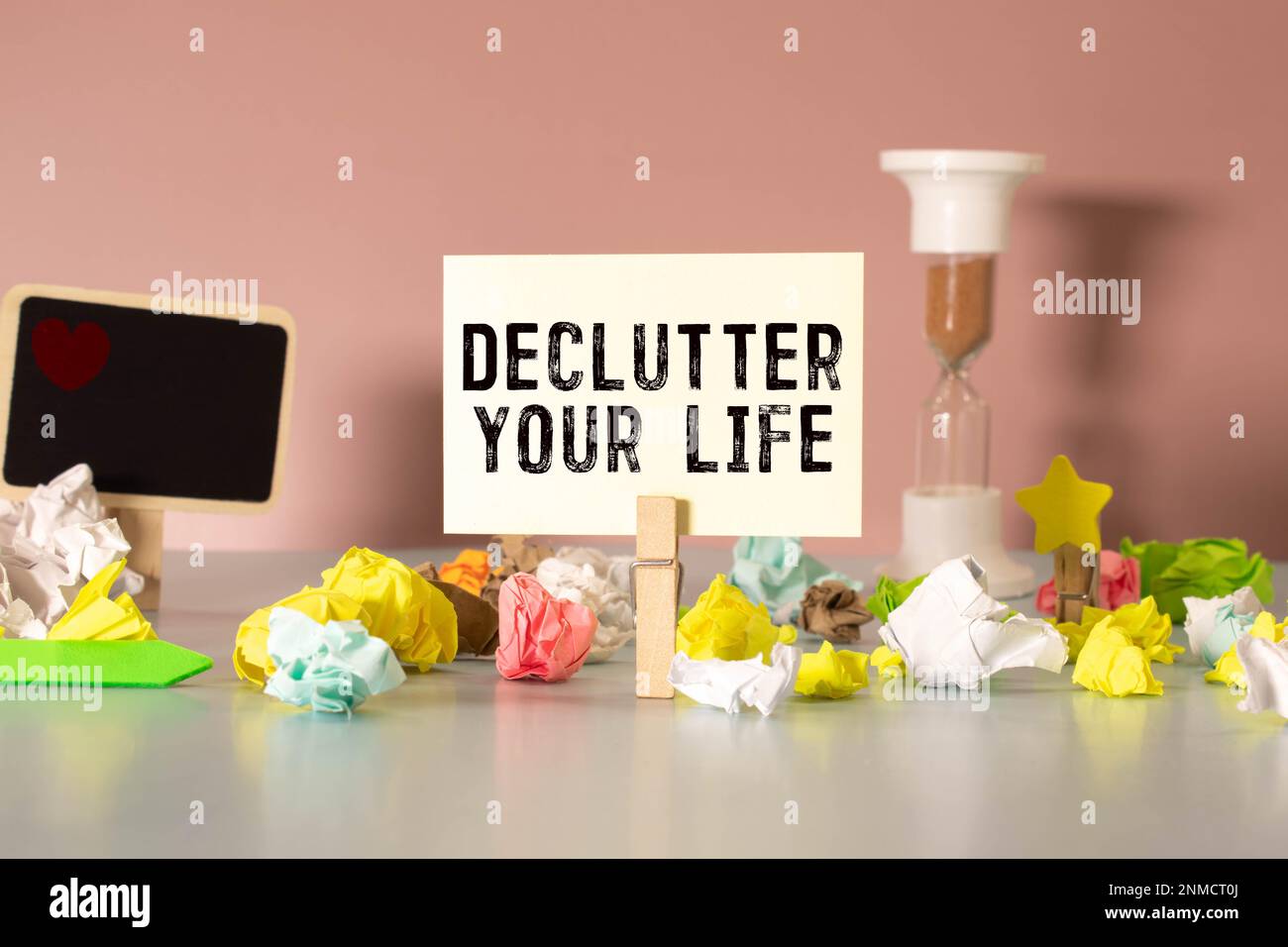 Pink office desk with keyboard and notebook, text DECLUTTER YOUR LIFE Stock Photo - Alamy
