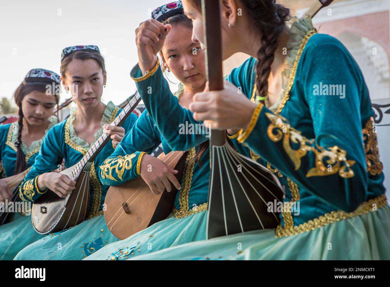 women playing dutar, folk show,in Rukhobod Mausoleum, Samarkand ...