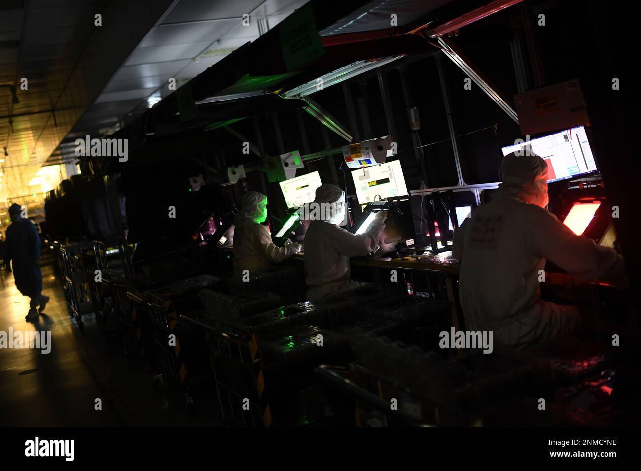 People work in a cleanroom of the production of LTPS (Low-Temperature ...