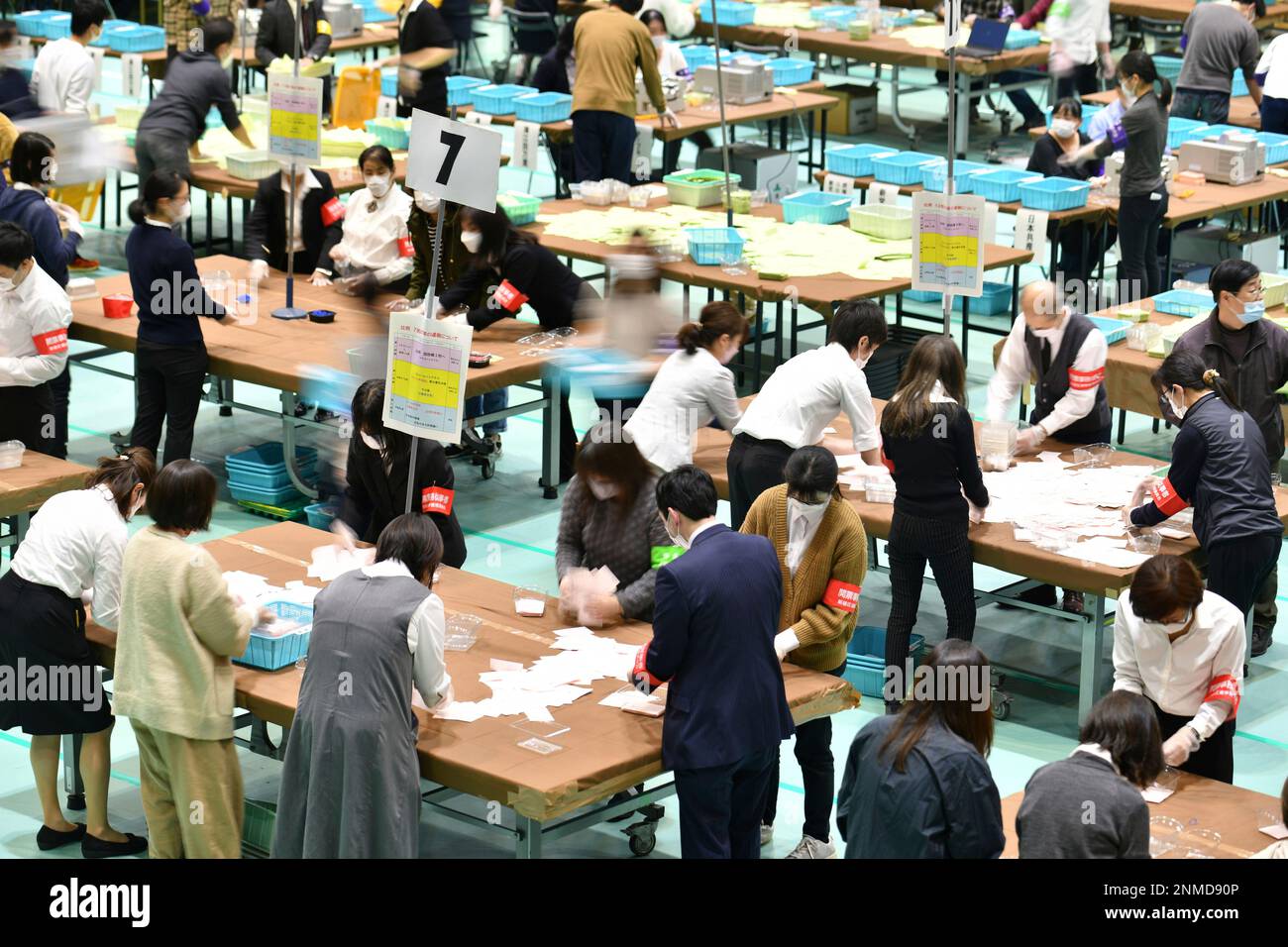 Election officials count votes of a general election at a ballot ...