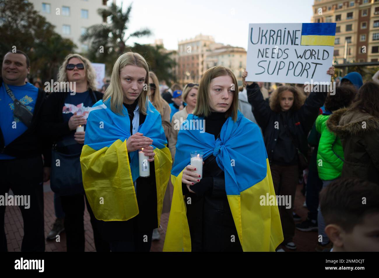 Malaga, Spain. 24th Feb, 2023. Two protesters wrapped with Ukrainian ...
