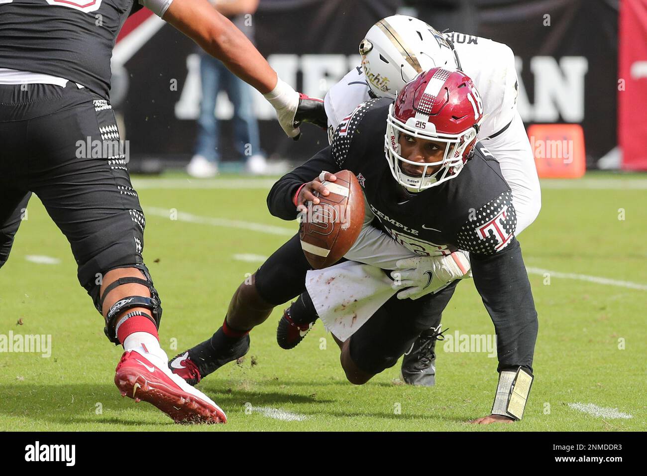 Temple quarterback D'Wan Mathis (18) is sacked by UCF defensive lineman ...