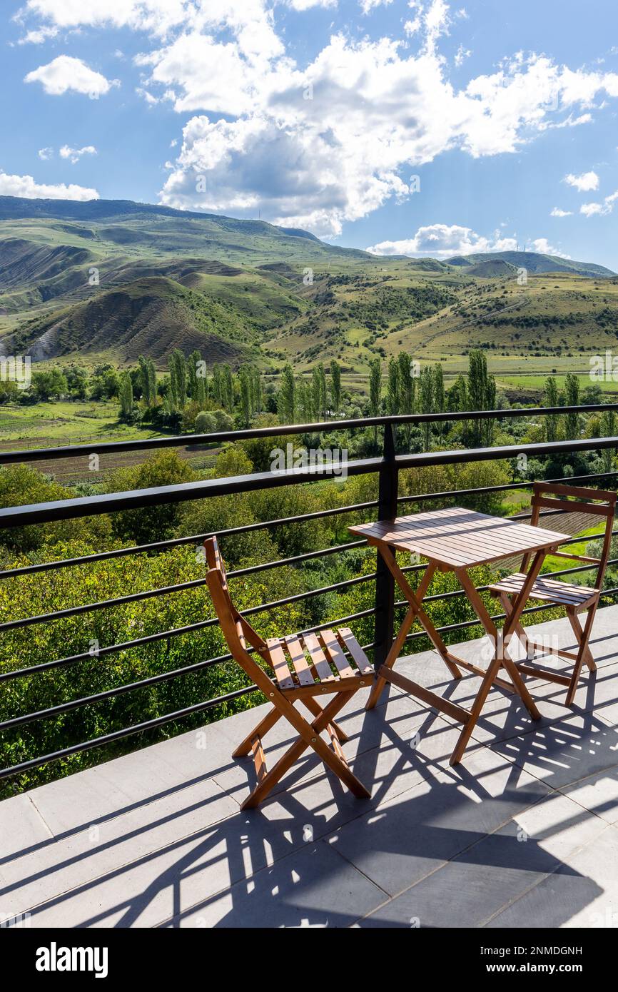 Table with two chairs on a wooden terrace in Aspindza town, Georgia ...