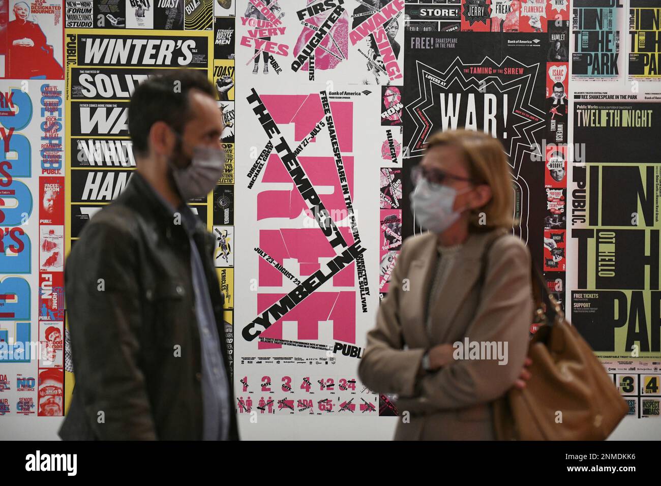 Two people in the exhibition of the designer Paula Scher, presented by ...