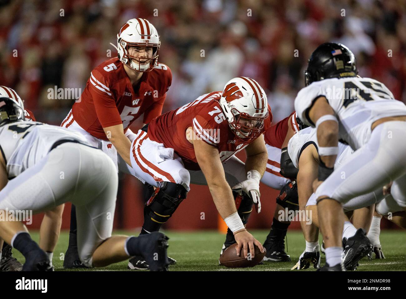 Wisconsin Badgers quarterback Graham Mertz (5) lines up under center ...