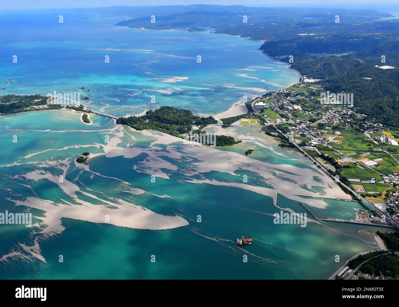 An aerial photo shows seashore covered with a large volume of pumice ...
