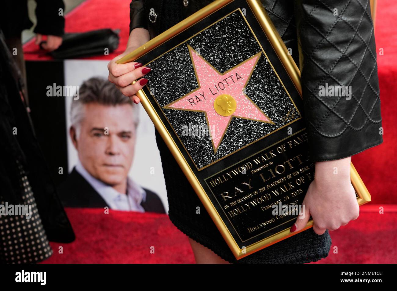 The late actor Ray Liotta's daughter Karsen holds a replica of a ...