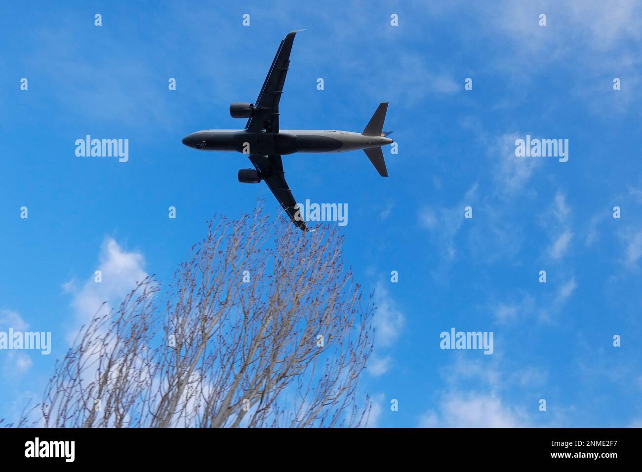 Commercial aircraft overflying the sky and arriving at airport Stock ...