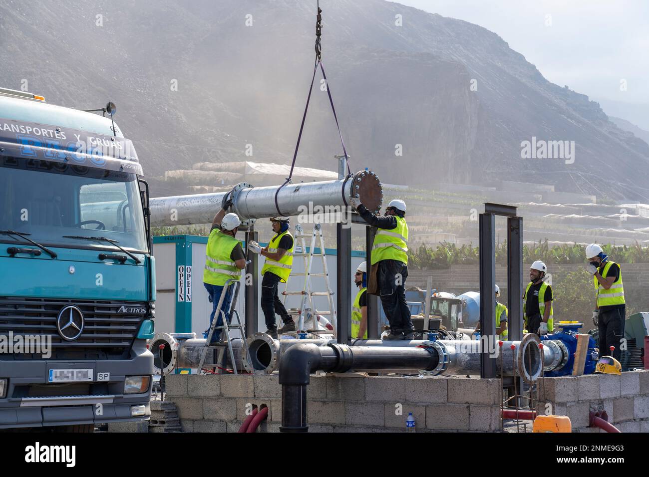 Operators work on the installation of water mixing tanks for the ...