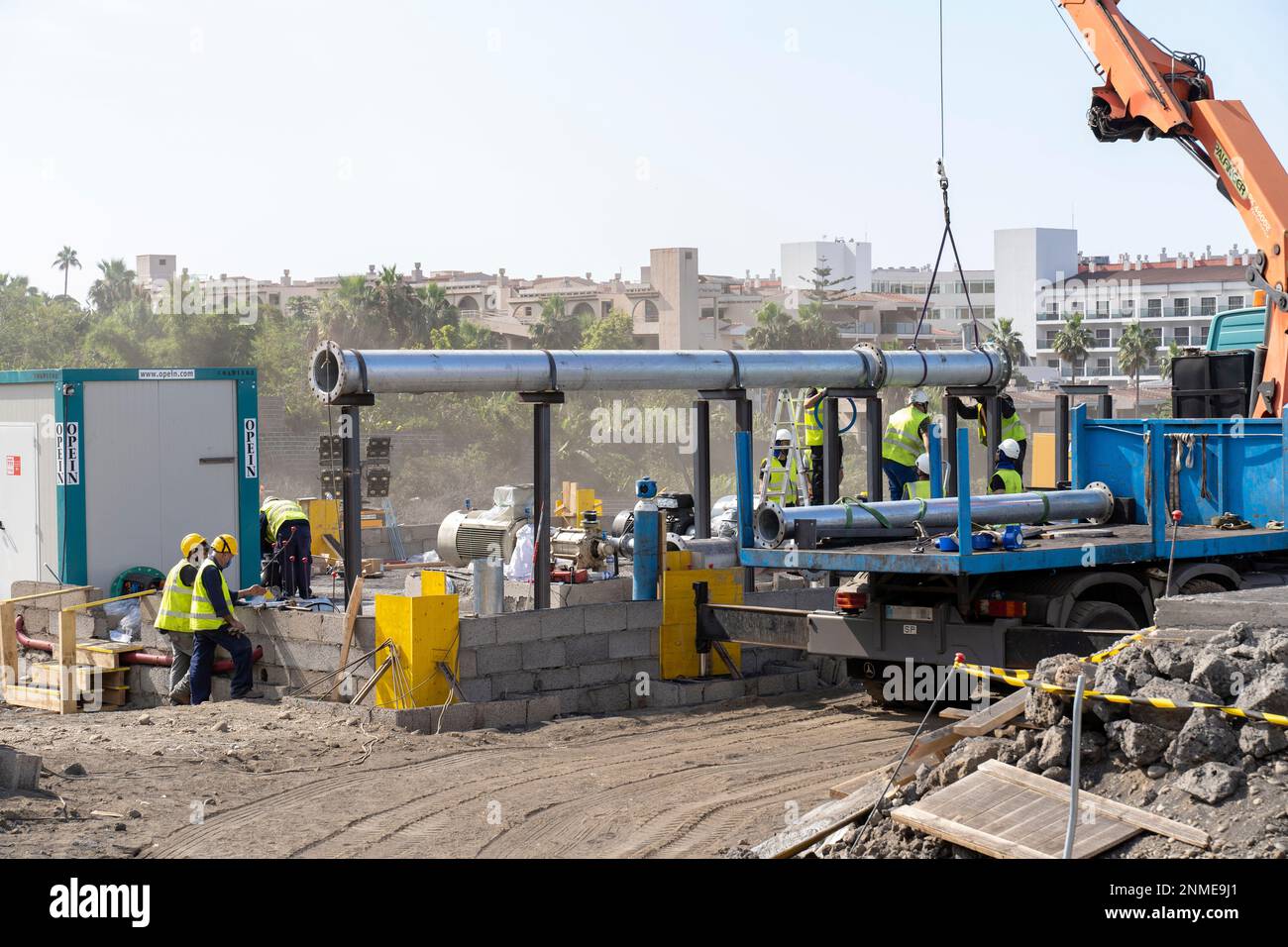 Operators work on the installation of water mixing tanks for the ...