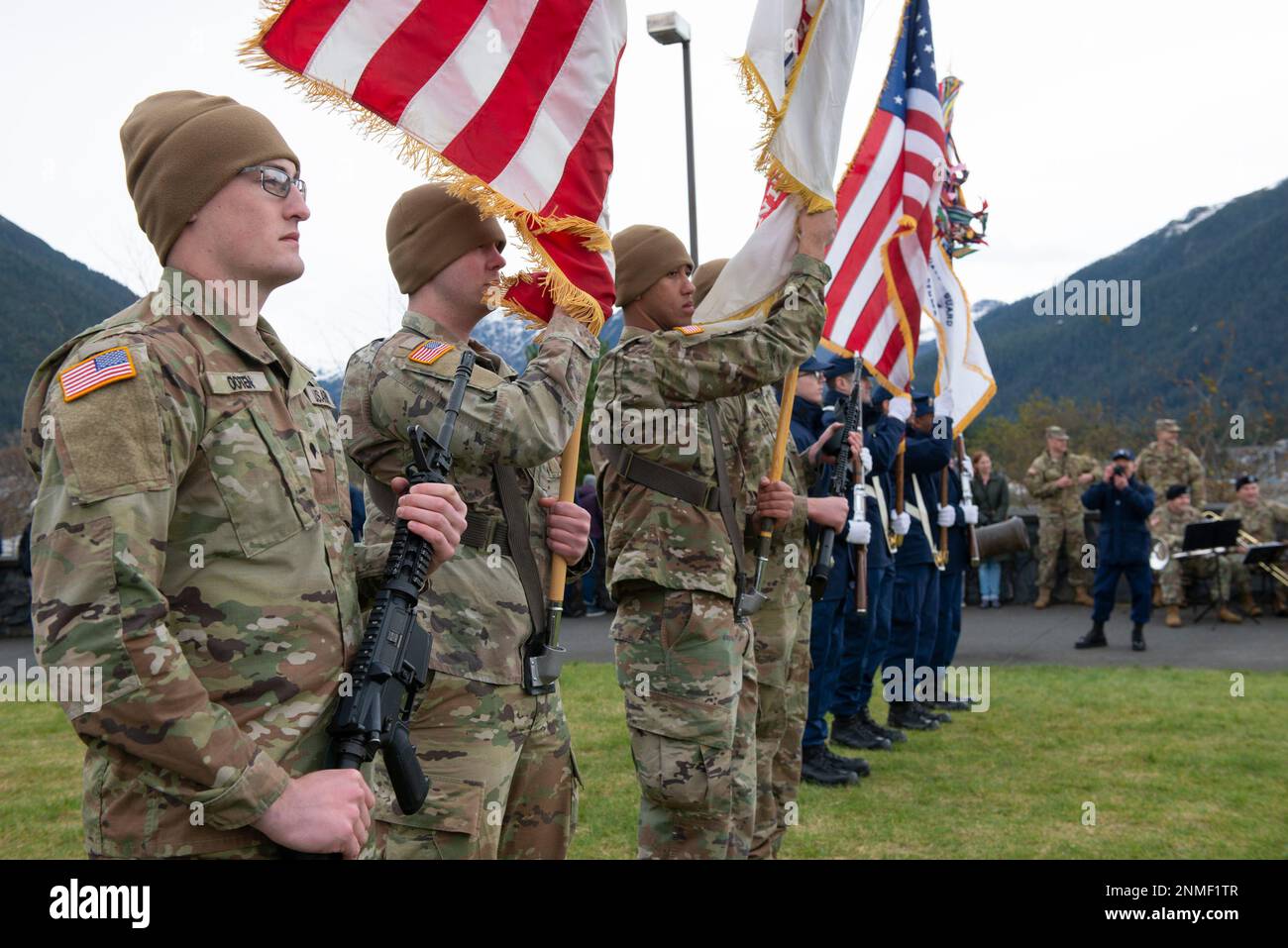 An Army color guard from Fort Richardson stands with a color guard from ...