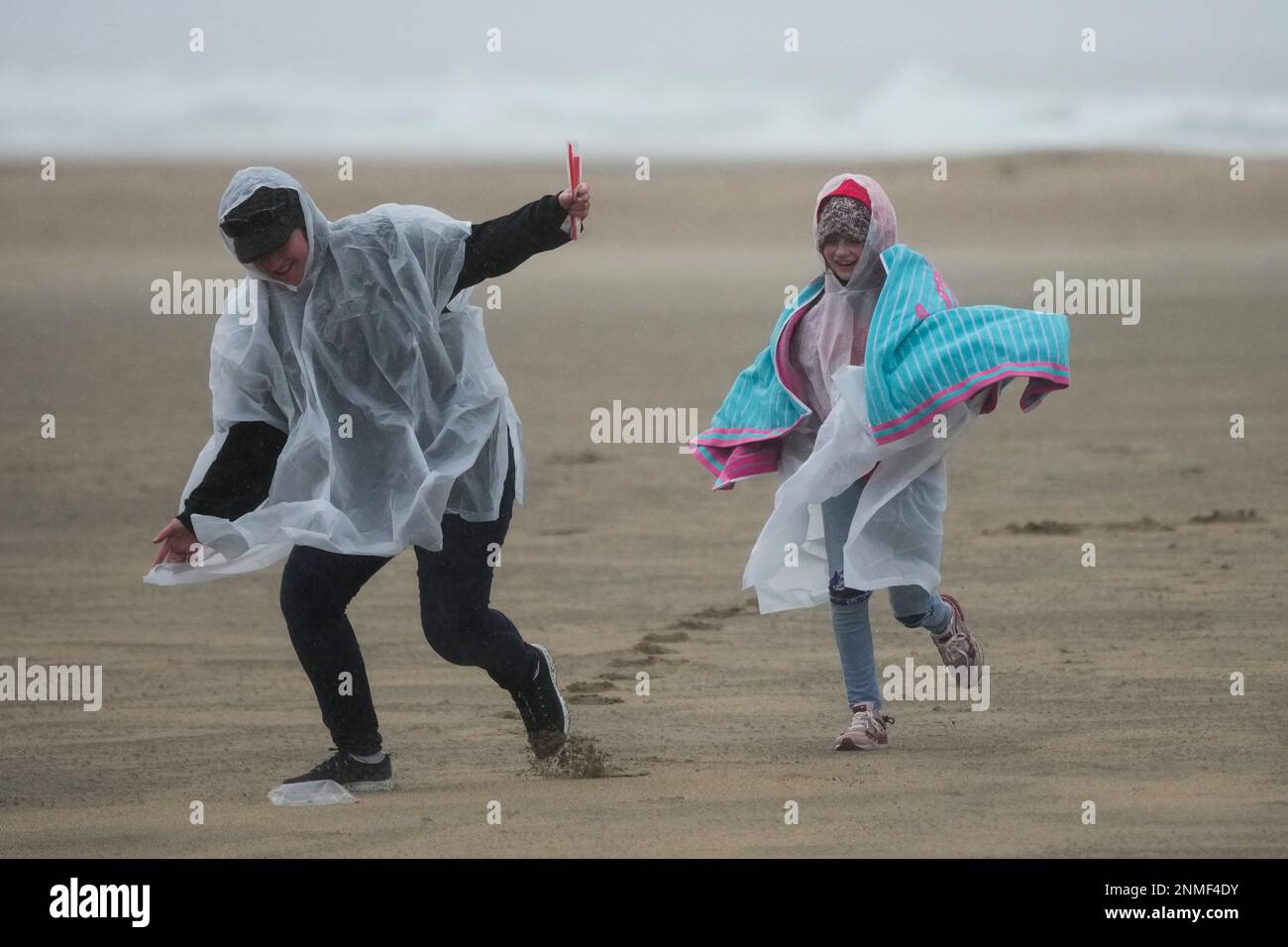 Beach combers run along the beach on Friday, Feb. 24, 2023, in ...