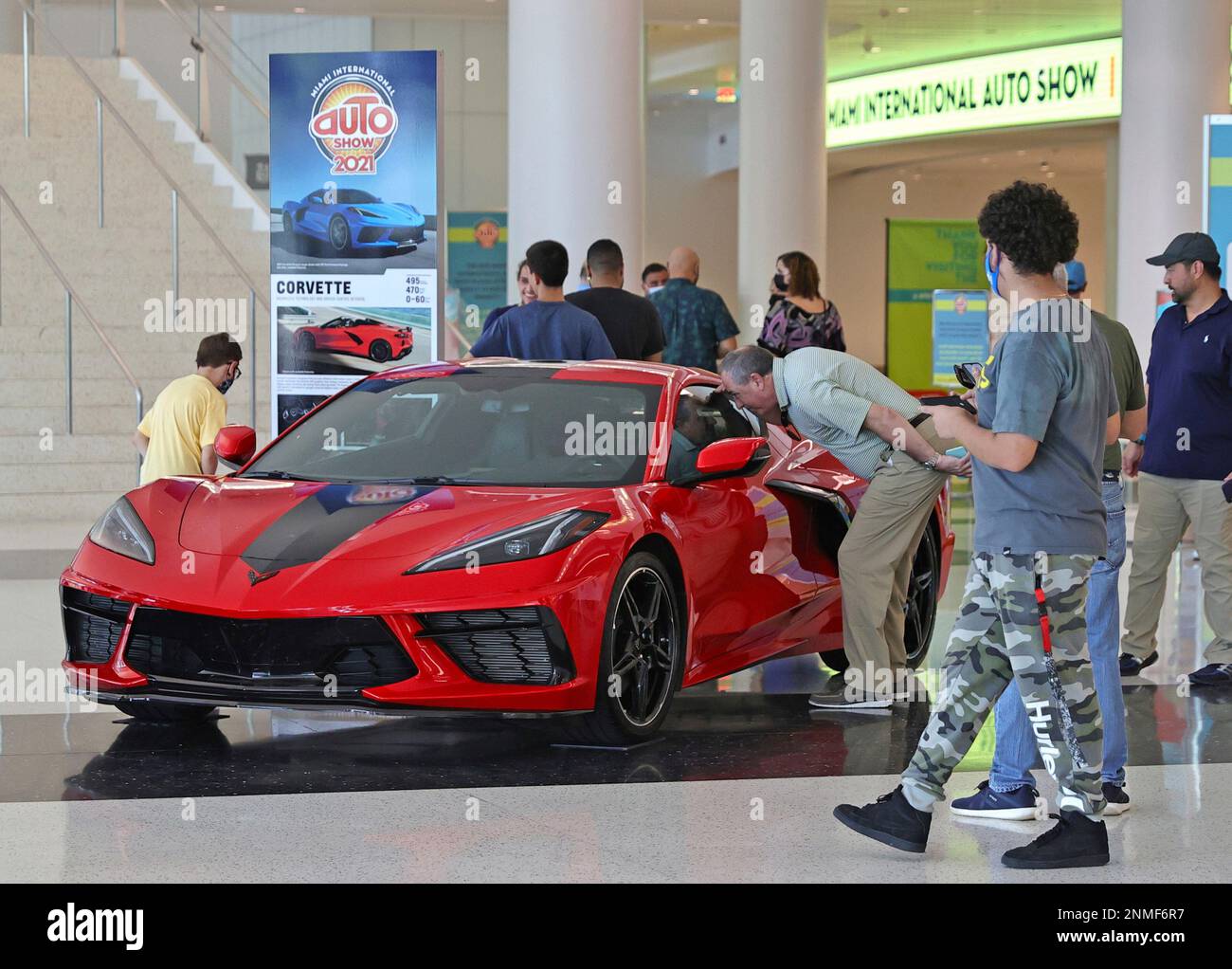 Visitors look at the 2022 Chevrolet Corvette at the Miami International ...
