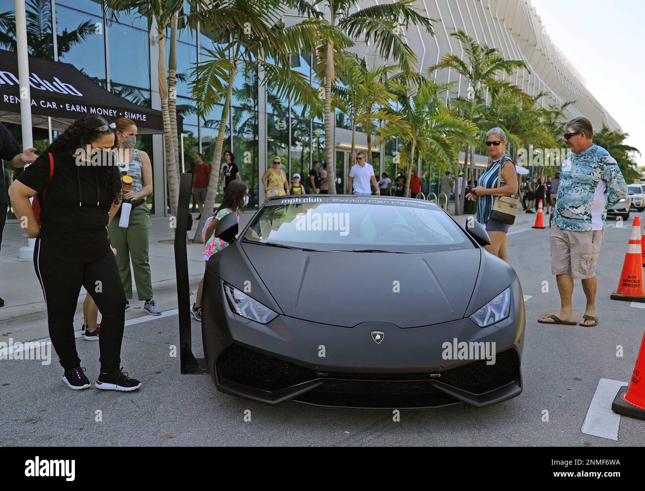 Car enthusiasts gather around a Lamborghini Aventador at the Miami ...