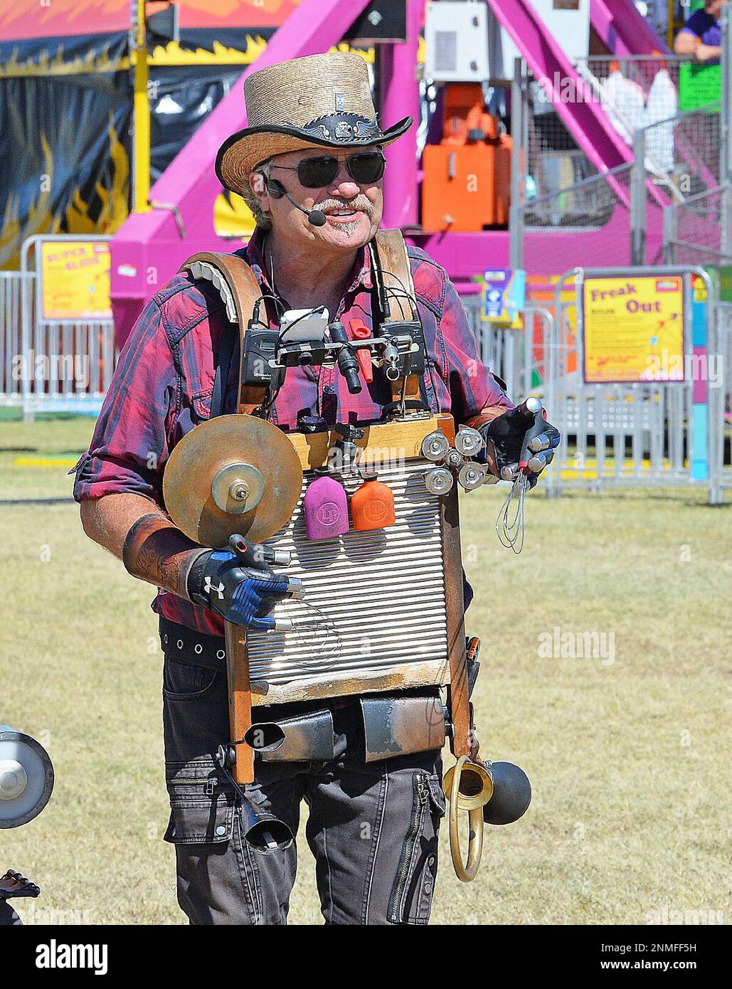 Larry Hiskett, better known as "Washboard Willy," greets people ...