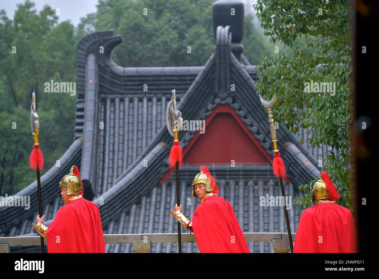 Men dressed in ancient warrior outfits stand guard in a ceremony ...