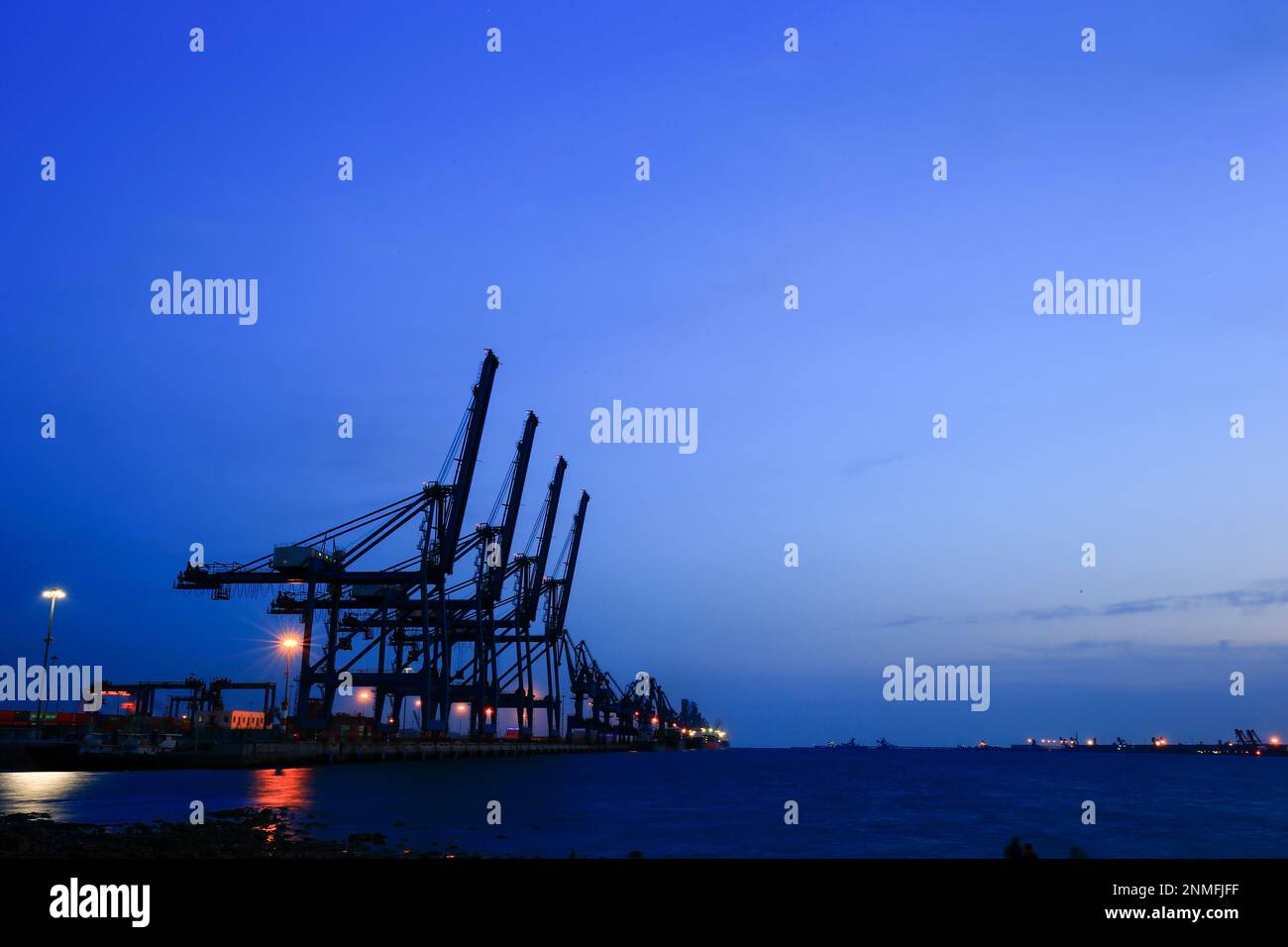 Port crane unloading container ships Stock Photo - Alamy