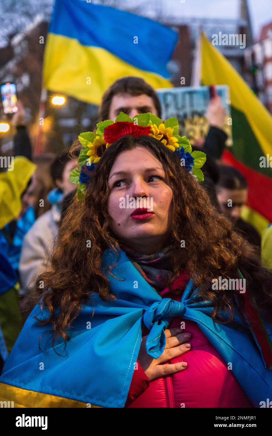 Woman with a wreath of red flowers at the 'Heartbroken but Unbroken ...