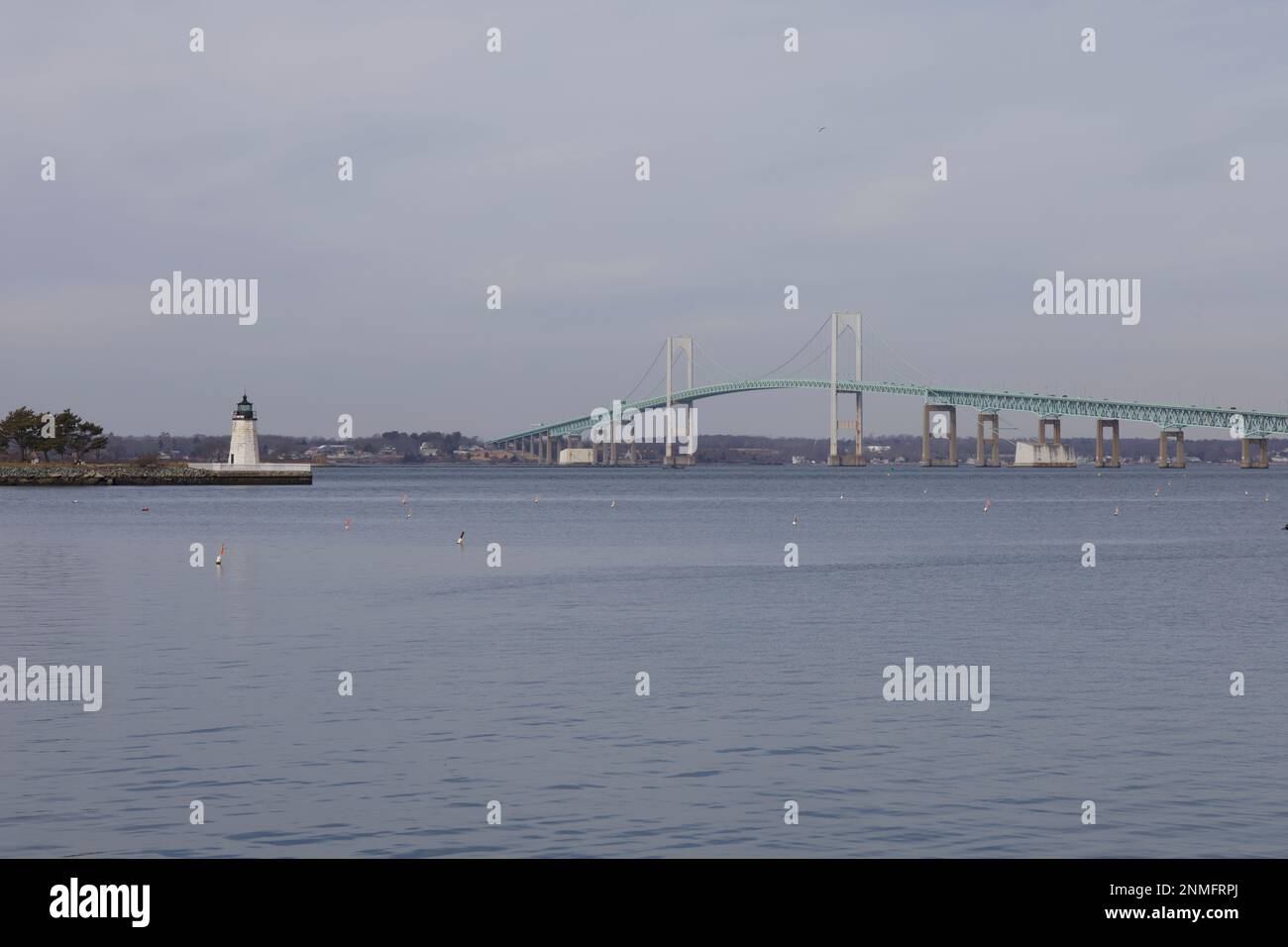 View of Goat Island Lighthouse, Newport Bridge, and surrounding waters of Newport Harbor in ...