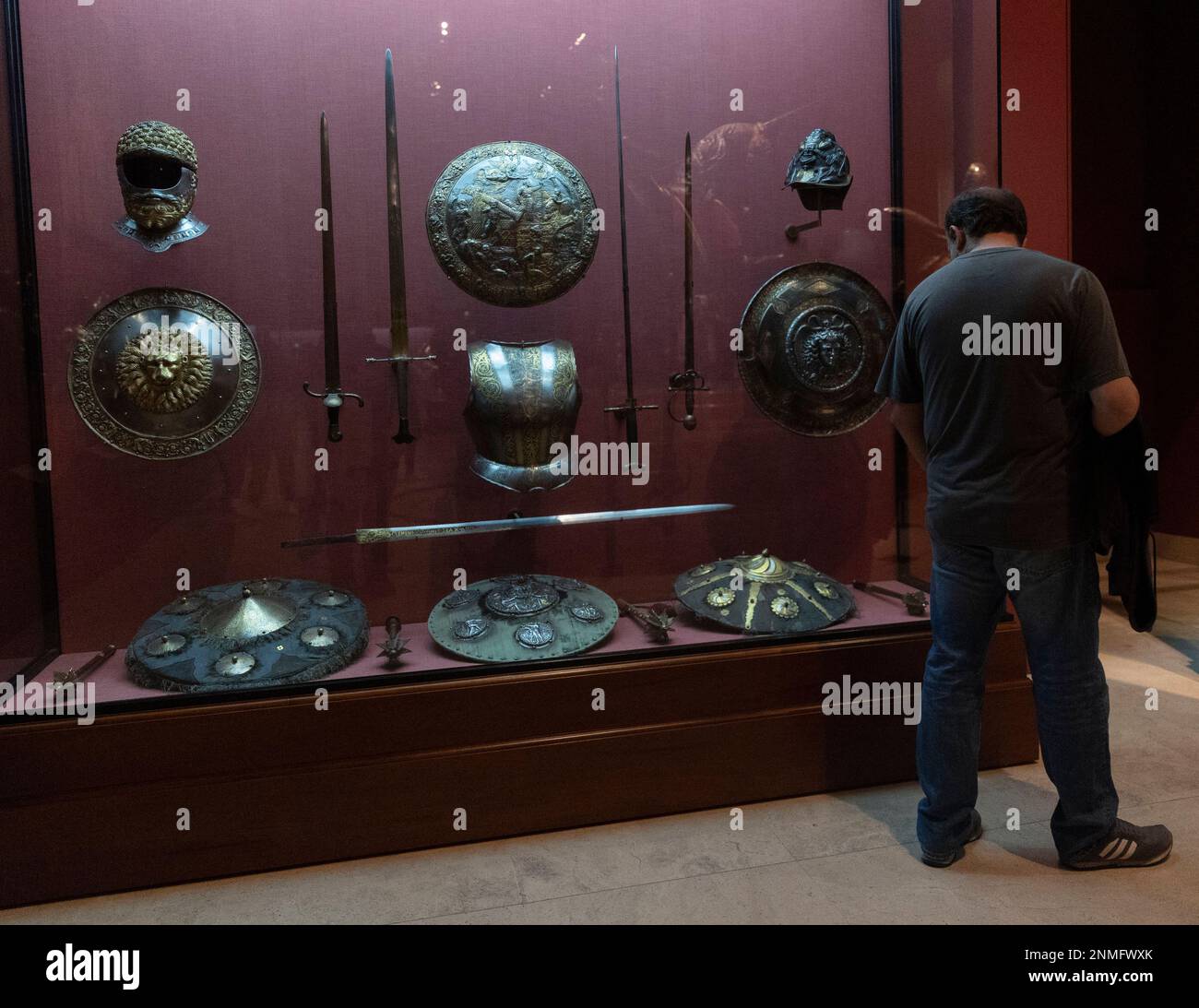A man observes some of the armor on display in the Royal Armory of the ...