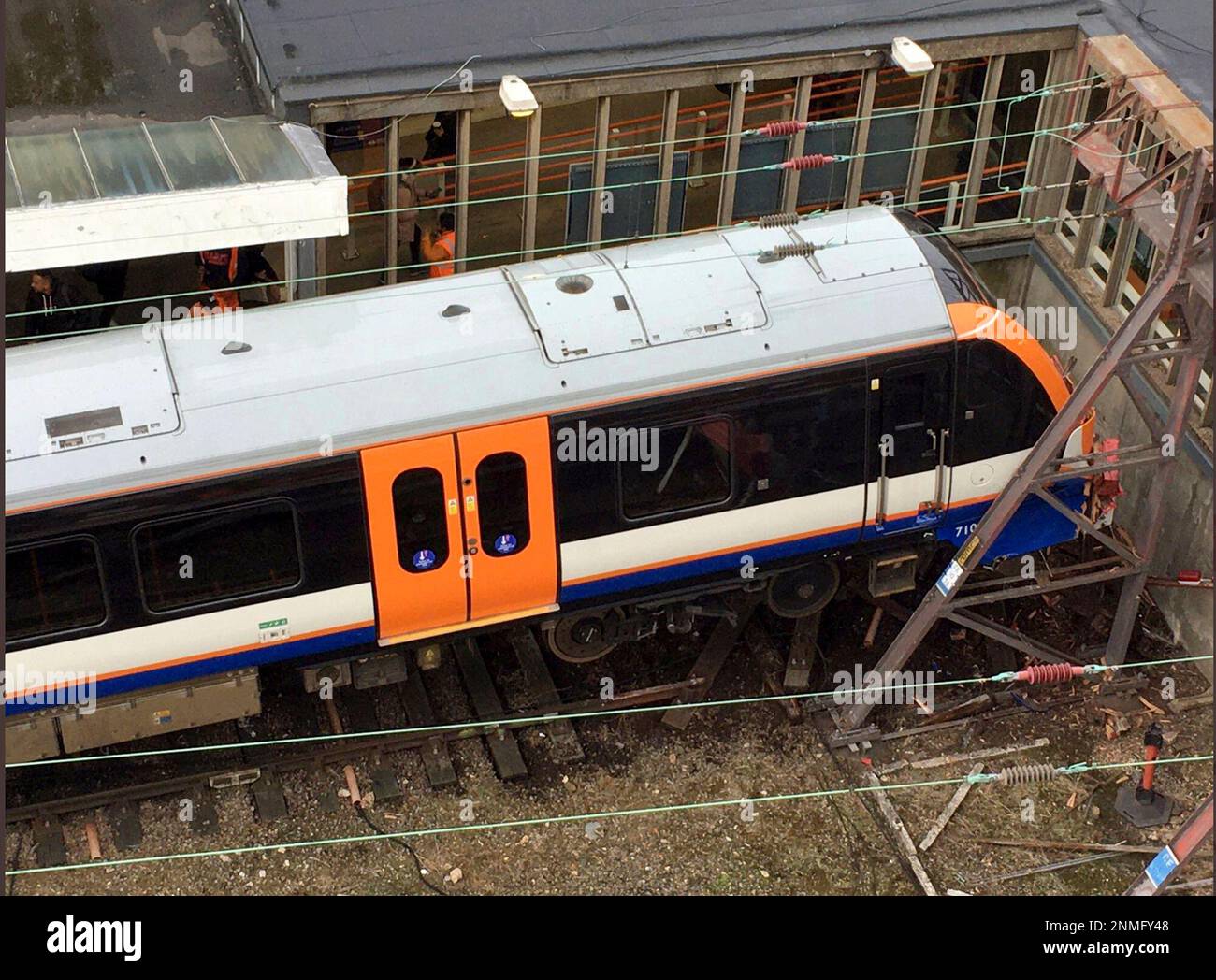 A train of the London Overground is seen after crashing through buffers ...