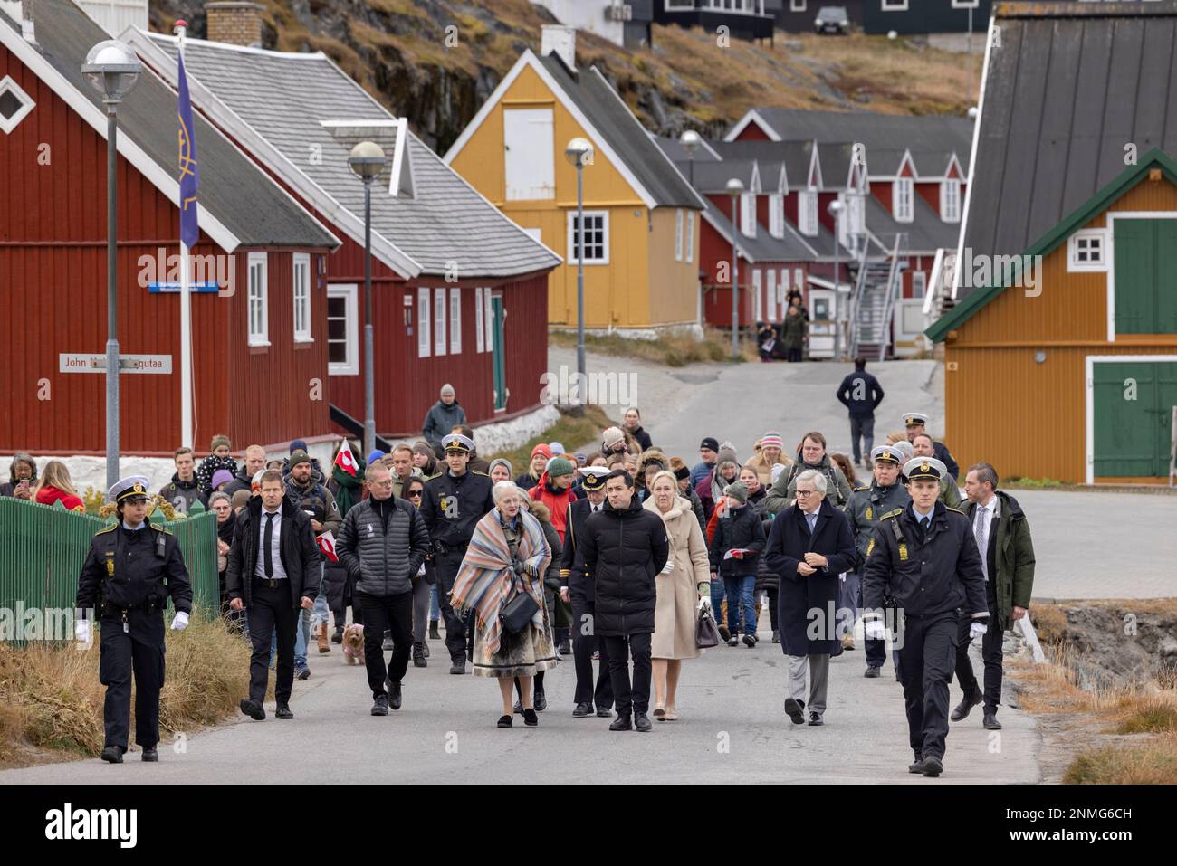 Denmark's Queen Margrethe, center left, walks with the chairman of the ...
