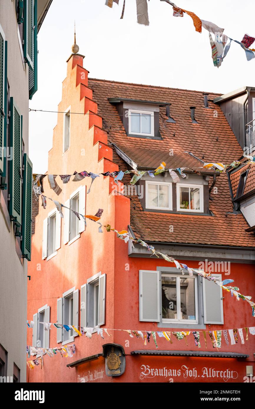 Hanging flags at carnival time in alleyway alley of the old town with ...