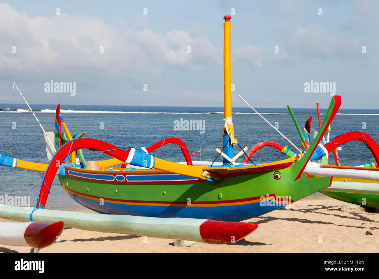 Brightly painted fishing outriggers on the beach at Sanur, Bali ...