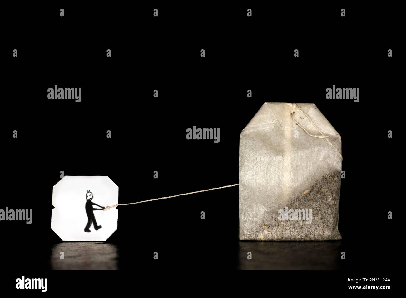 Fun photo, stick figure pulling on a tea bag, studio photography with ...
