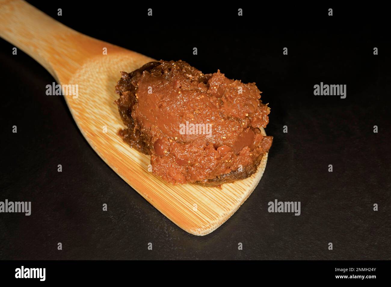 Doenjang, traditional fermented Korean soybean paste on a bamboo spoon ...