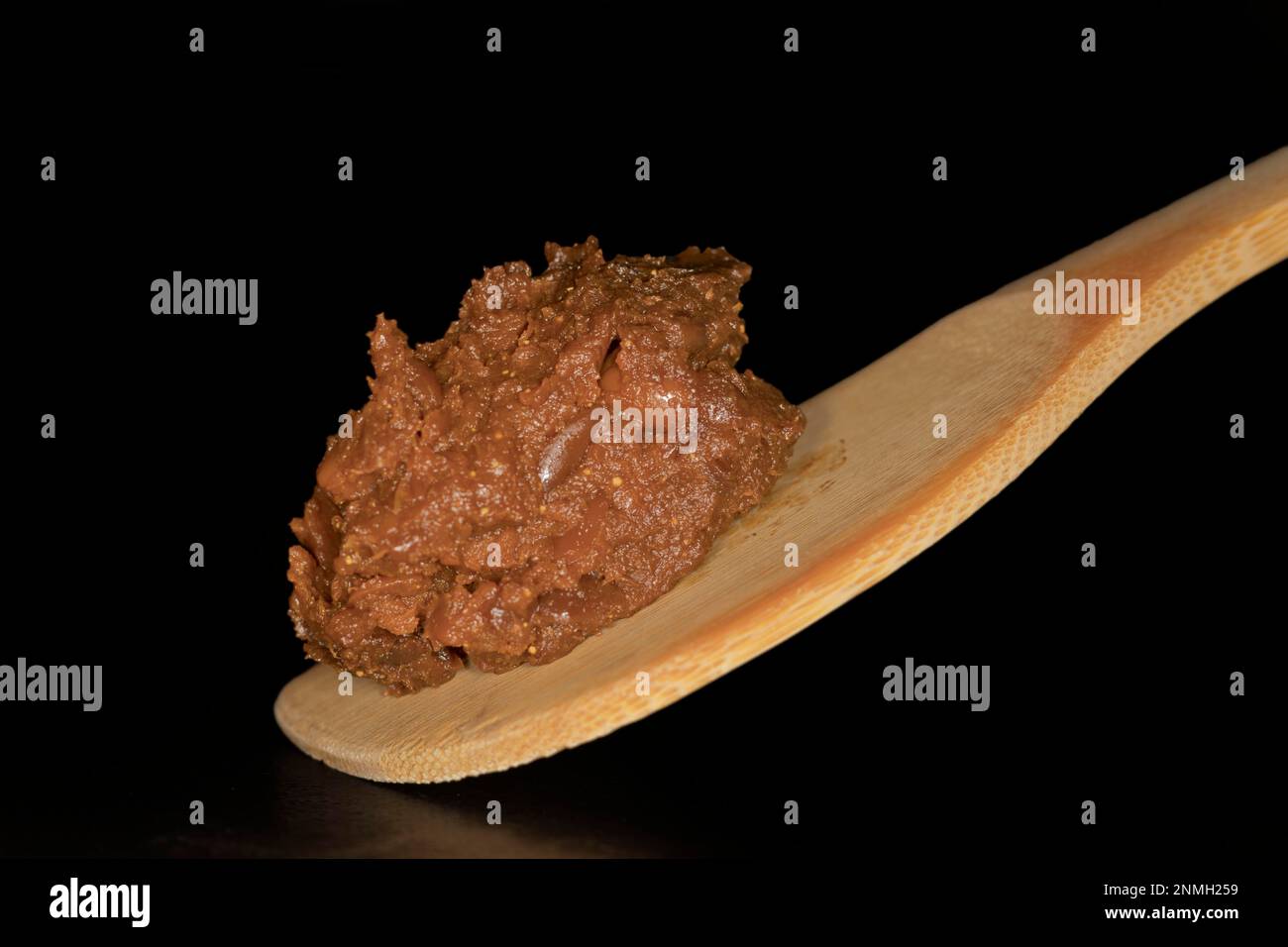 Doenjang, traditional fermented Korean soybean paste on a bamboo spoon ...