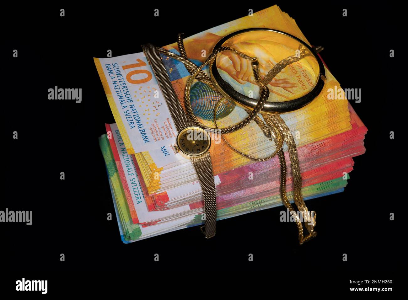 Symbol photo for black money in Switzerland, gold watch, gold bracelet ...
