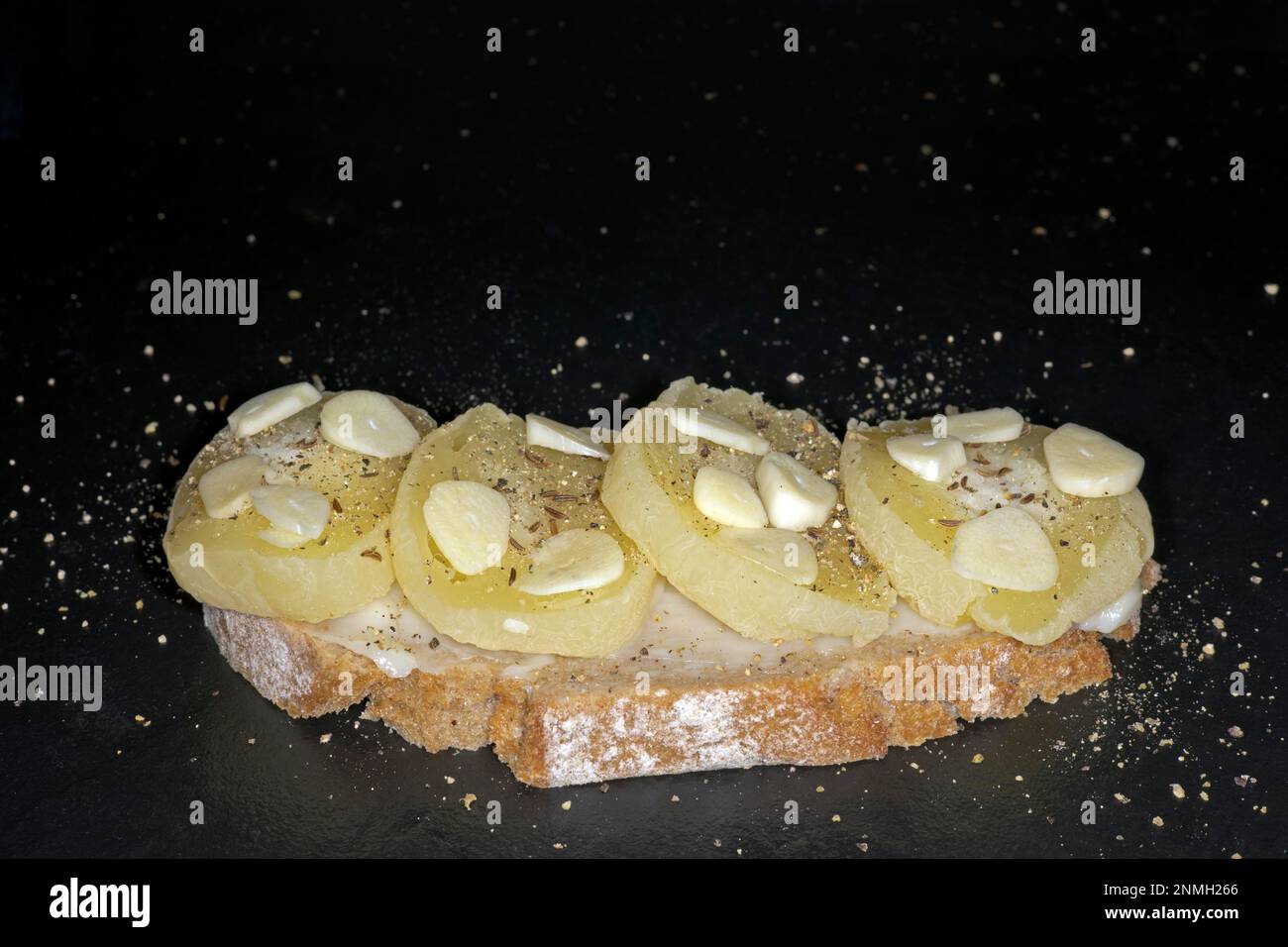 Harz cheese on mixed bread with lard, caraway seeds, grated pepper and ...