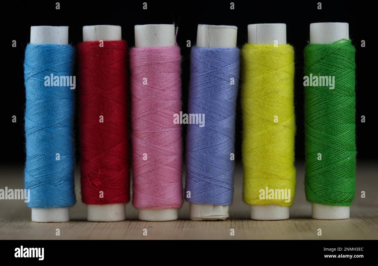 Six rolls of sewing thread in different colours Stock Photo - Alamy