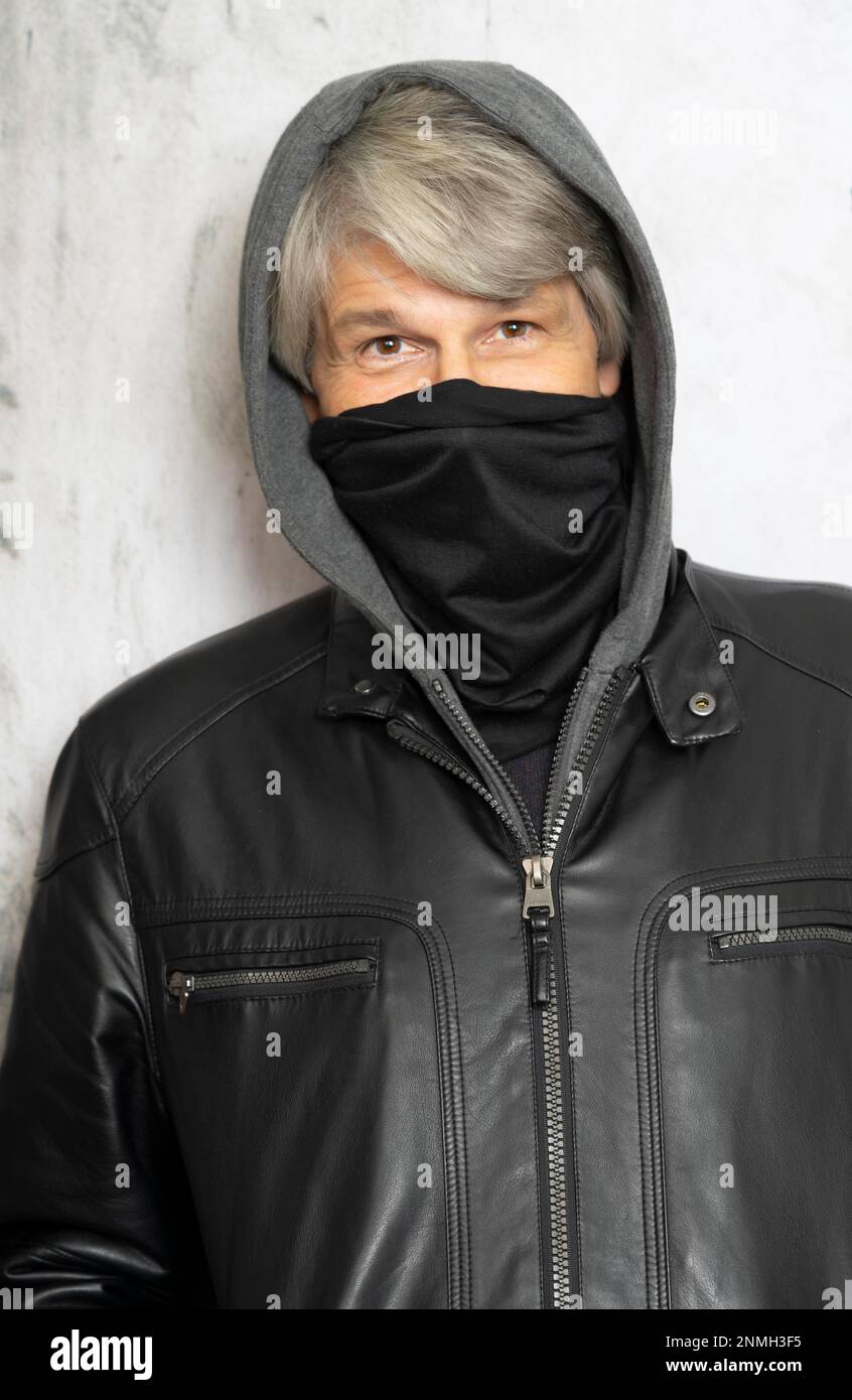 Older man with mask and leather jacket Stock Photo - Alamy