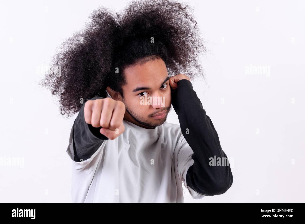 Boxing attack position. Young man with afro hair on white background ...