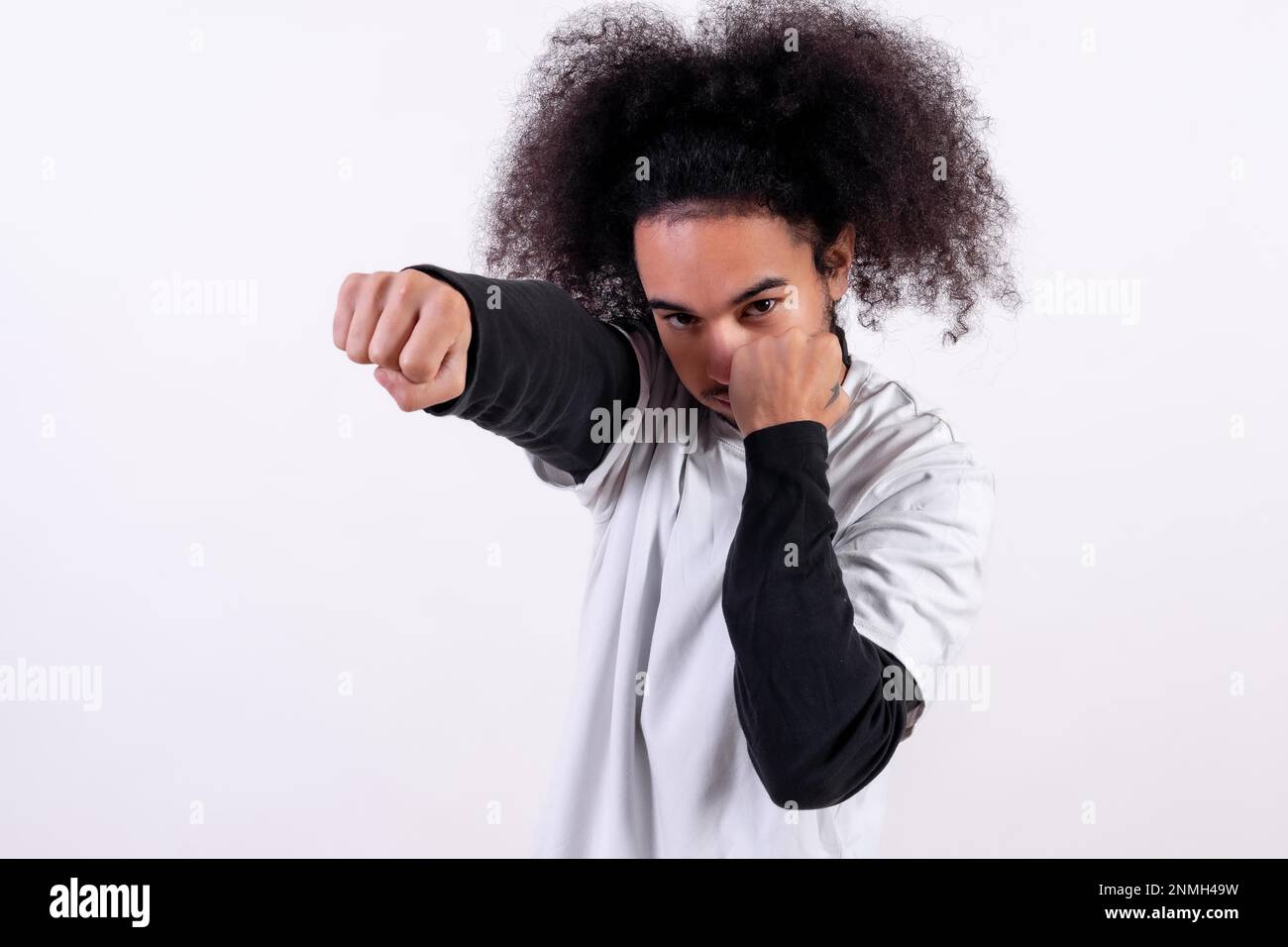 Boxing attack position. Young man with afro hair on white background ...