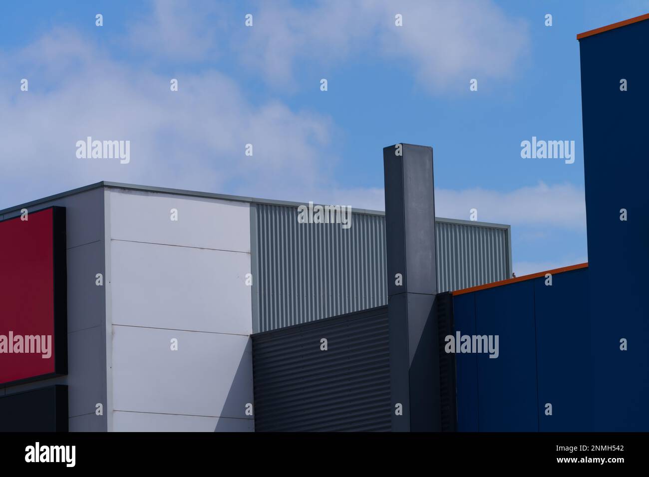 Abstract building structure, shape and design with a blue cloudy sky ...