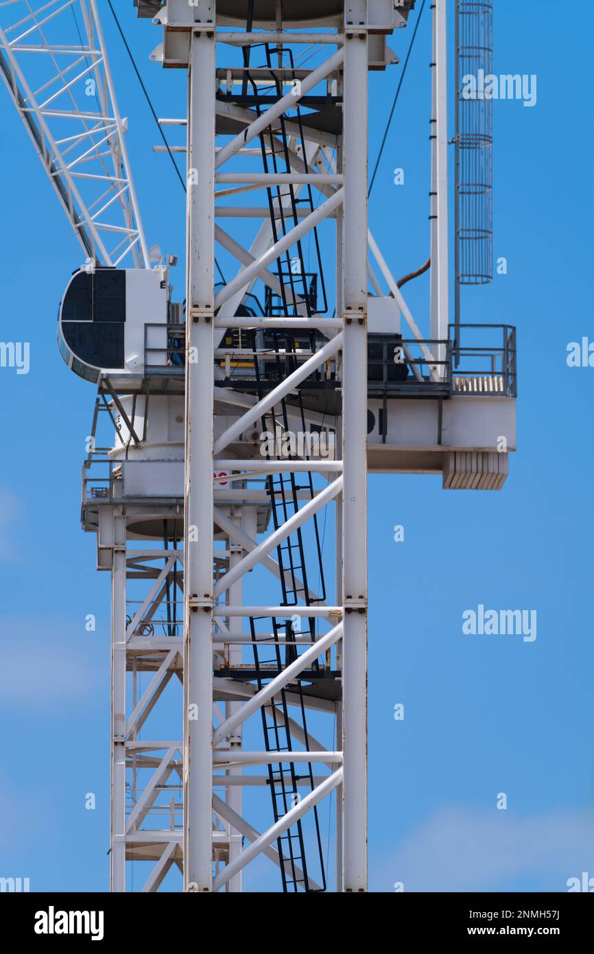 Skyscraper construction crane close up, on city building site with a ...