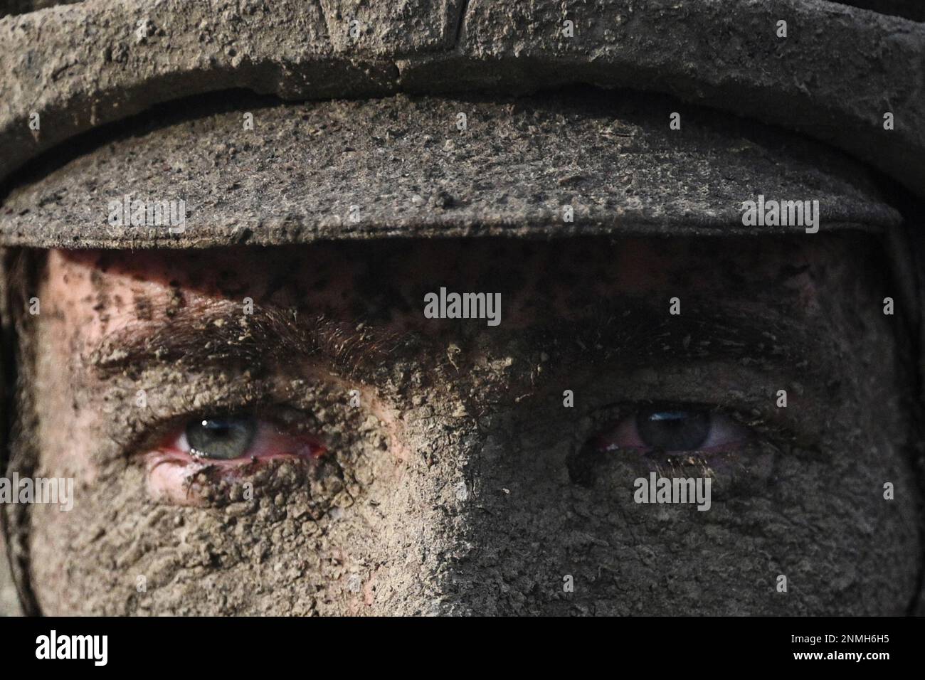 Mud covers the face of Stan Dewulf from Belgium after the men's Paris ...