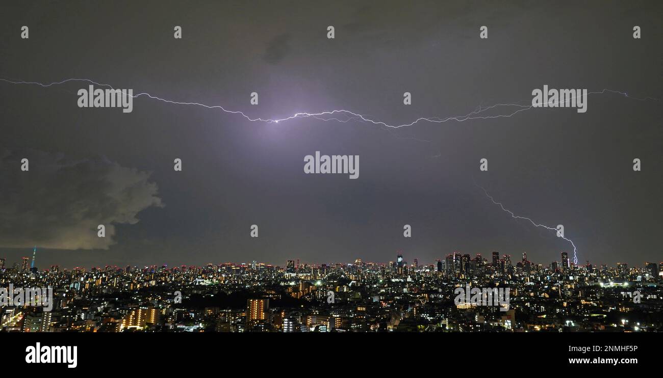 A thunder lightning strikes intermittently in the night sky in Nerima ...