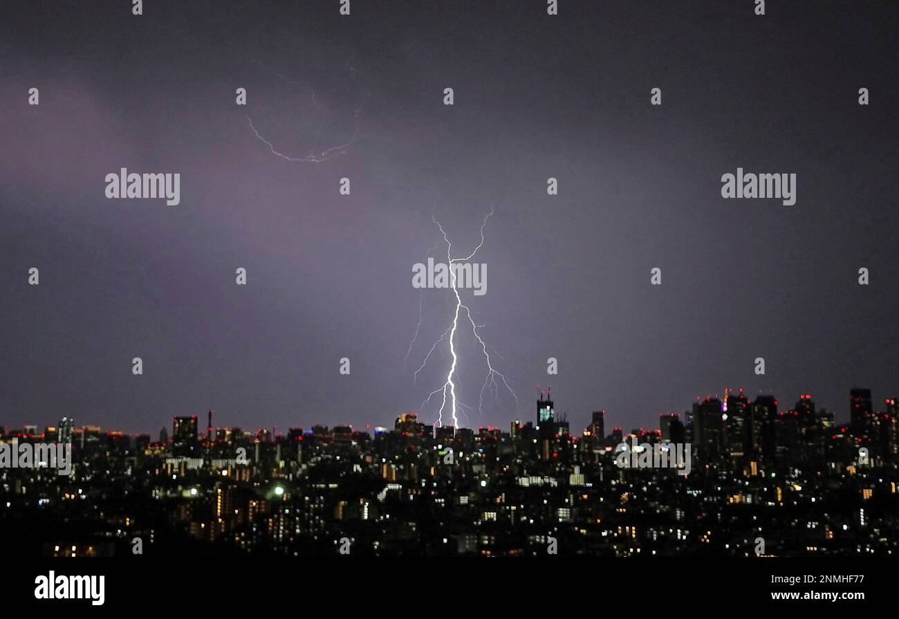 A thunder lightning strikes intermittently in the night sky in Nerima ...