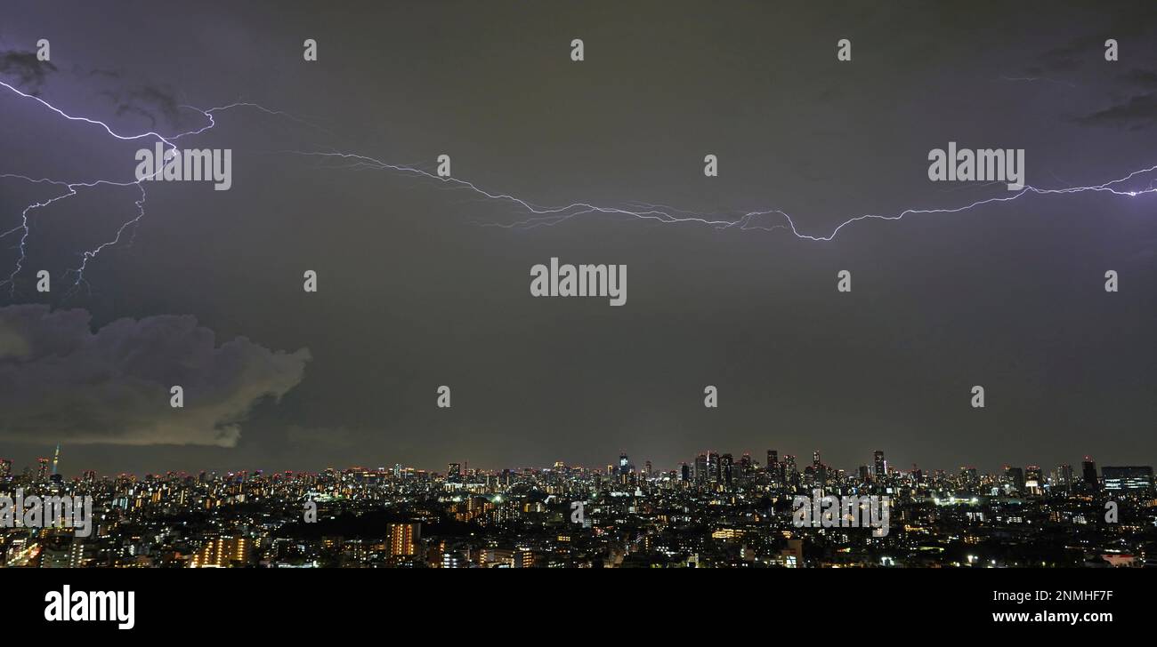 A thunder lightning strikes intermittently in the night sky in Nerima ...